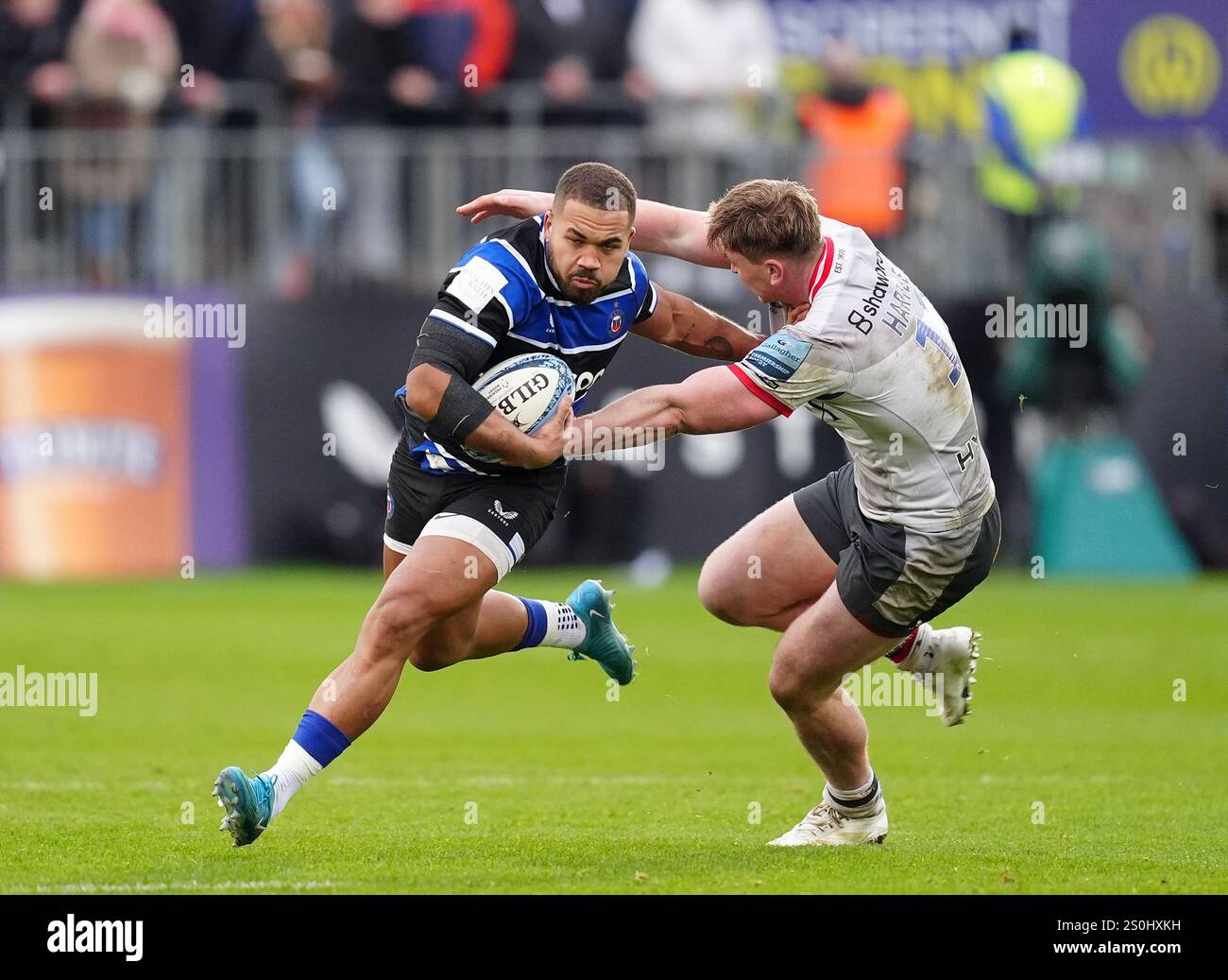Bath's Ollie Lawrence breaks the tackle of Saracens' Olly Hartley ...