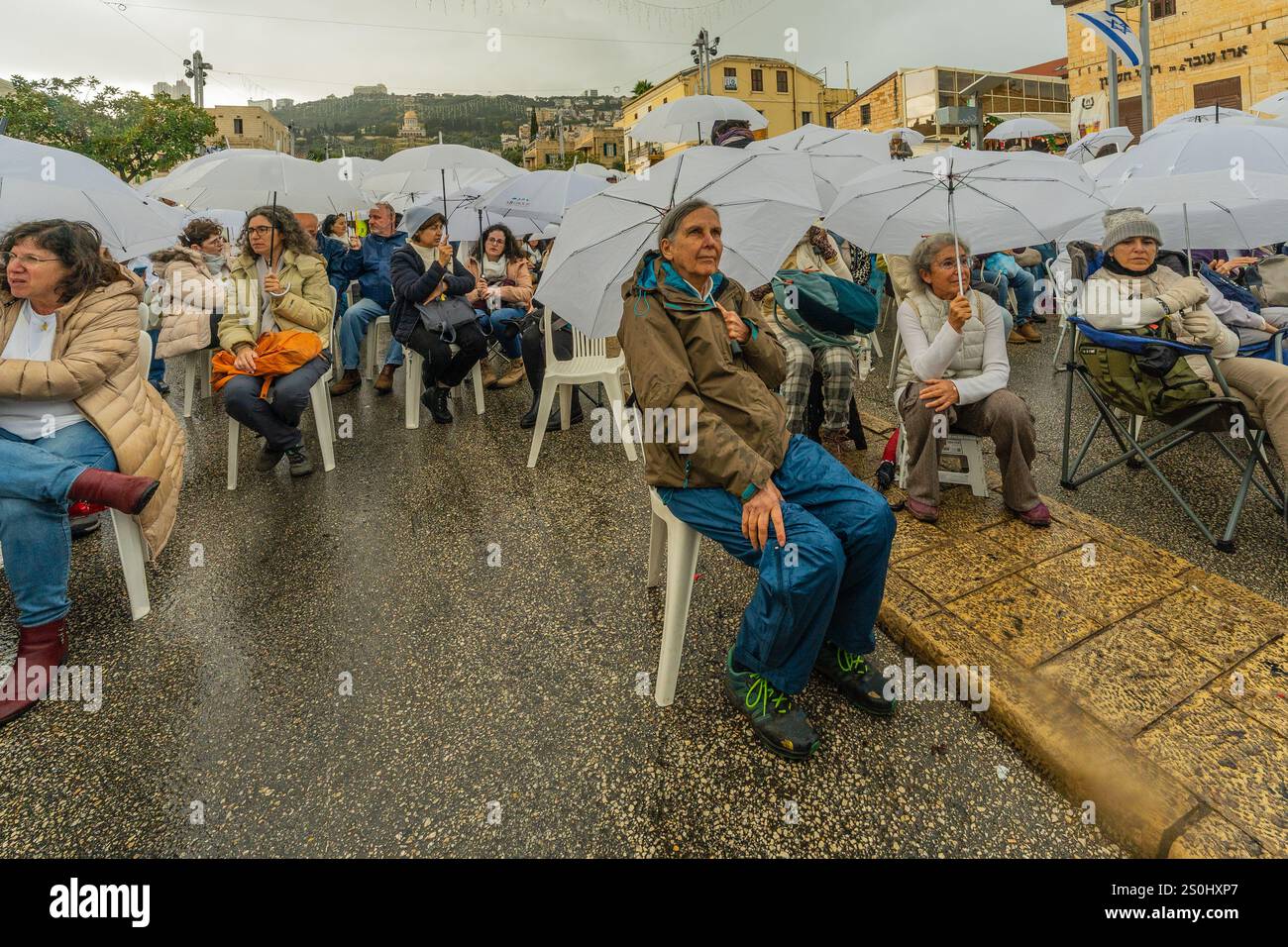 Haifa, Israel - December 27, 2024: People dressed in white seat under a ...
