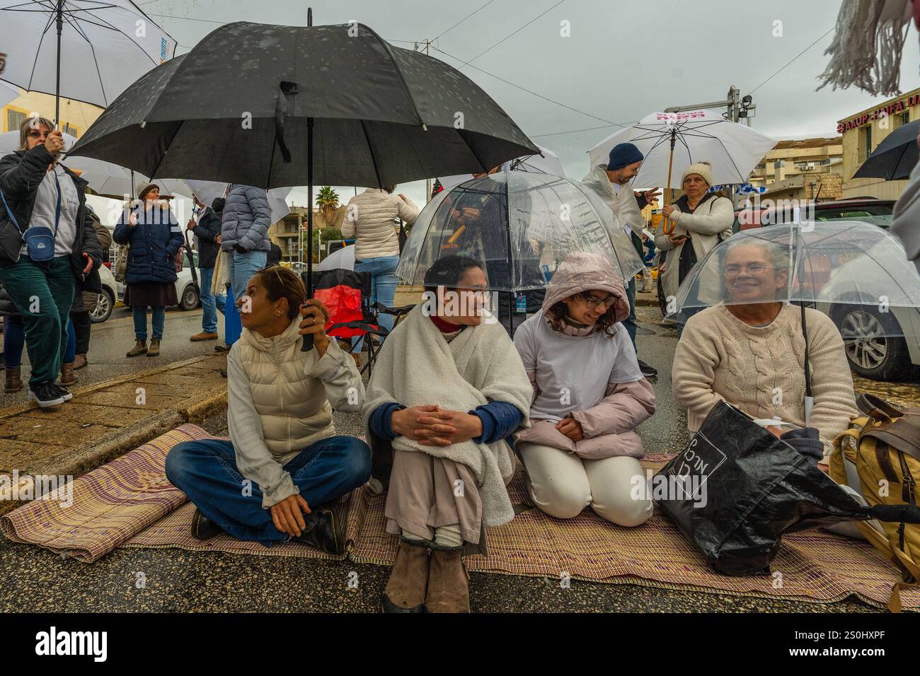 Haifa, Israel - December 27, 2024: People dressed in white seat under a ...
