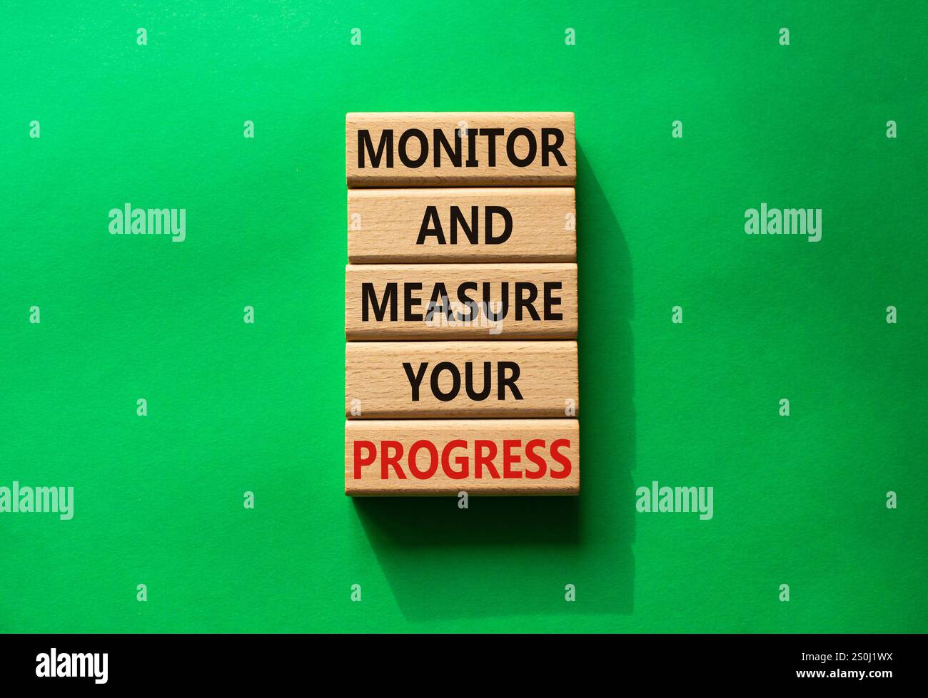 Monitor and Measure your Progress symbol. Wooden blocks with words ...