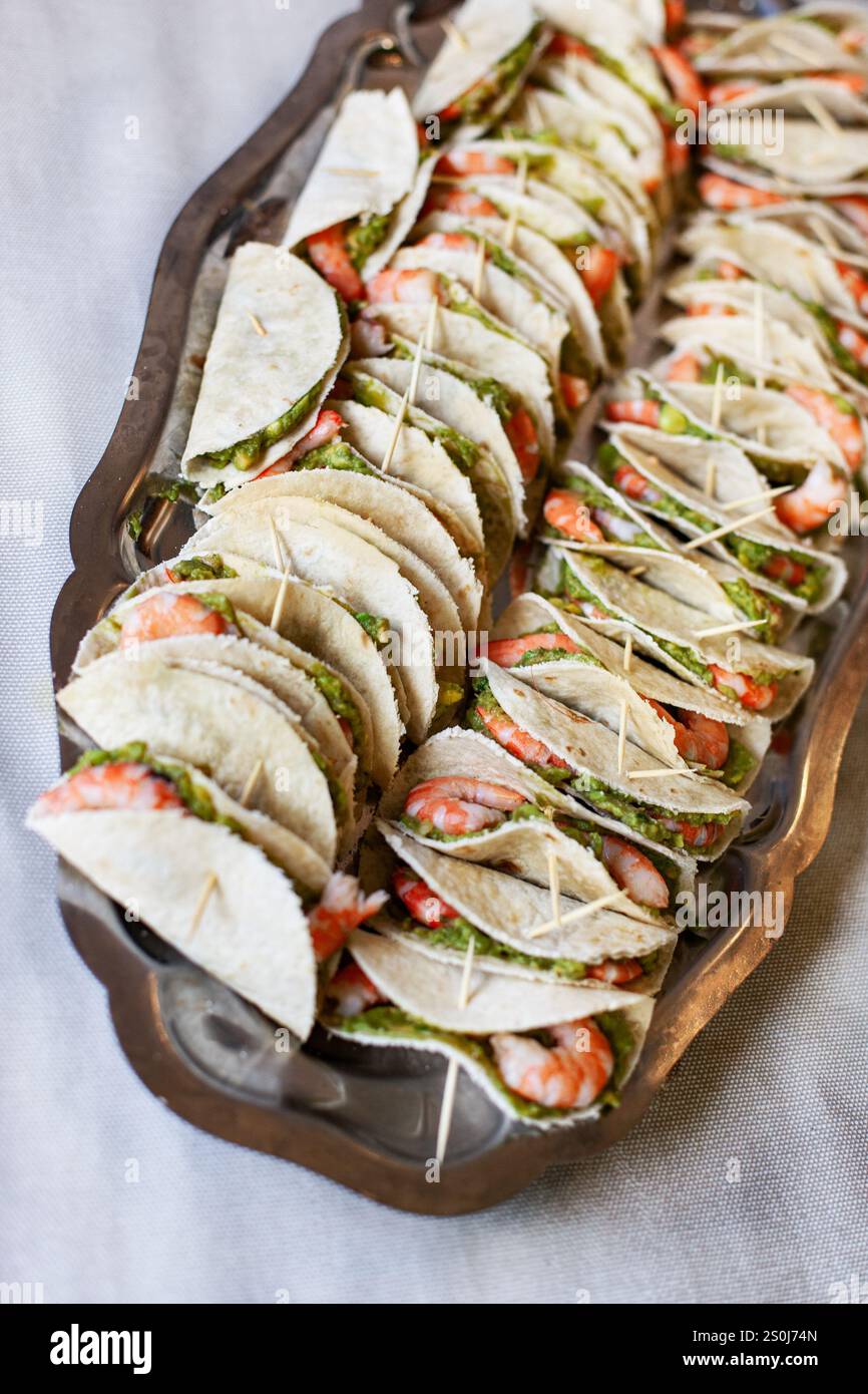 Small shrimp cakes with avocado mousse Stock Photo - Alamy