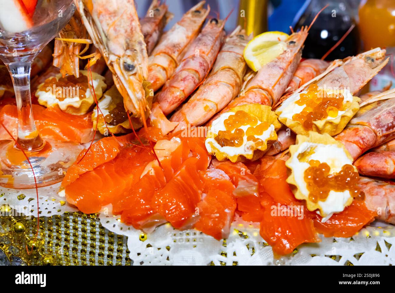 A beautifully arranged seafood platter features fresh shrimp and salmon ...