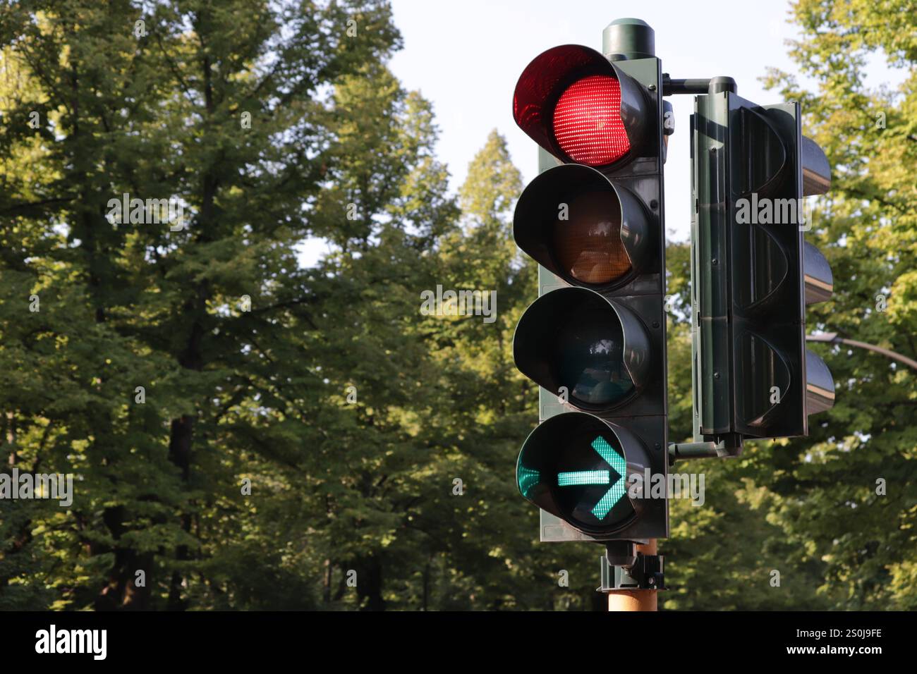 Traffic light with red light and green arrow for free right turn ...