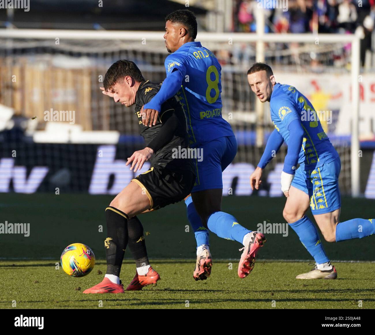 Genoa's Andrea Pinamonti, left, fights for the ball with Empoli's ...