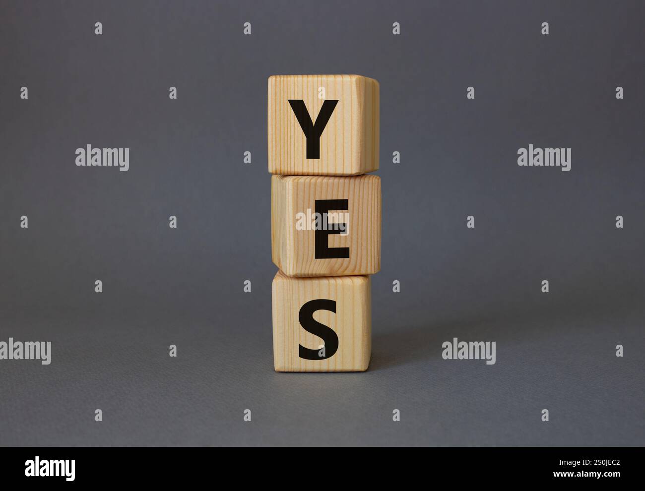 Yes symbol. Wooden blocks with word yes. Beautiful grey background ...