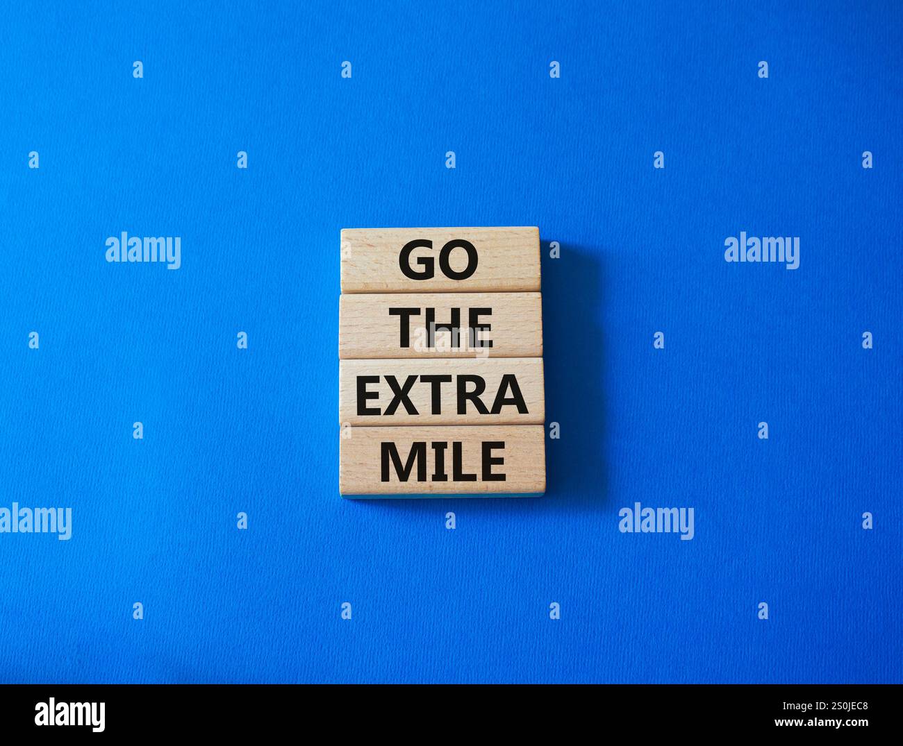 Go the extra mile symbol. Wooden blocks with words Go the extra mile ...