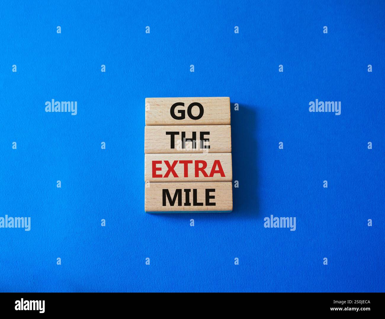 Go the extra mile symbol. Wooden blocks with words Go the extra mile ...