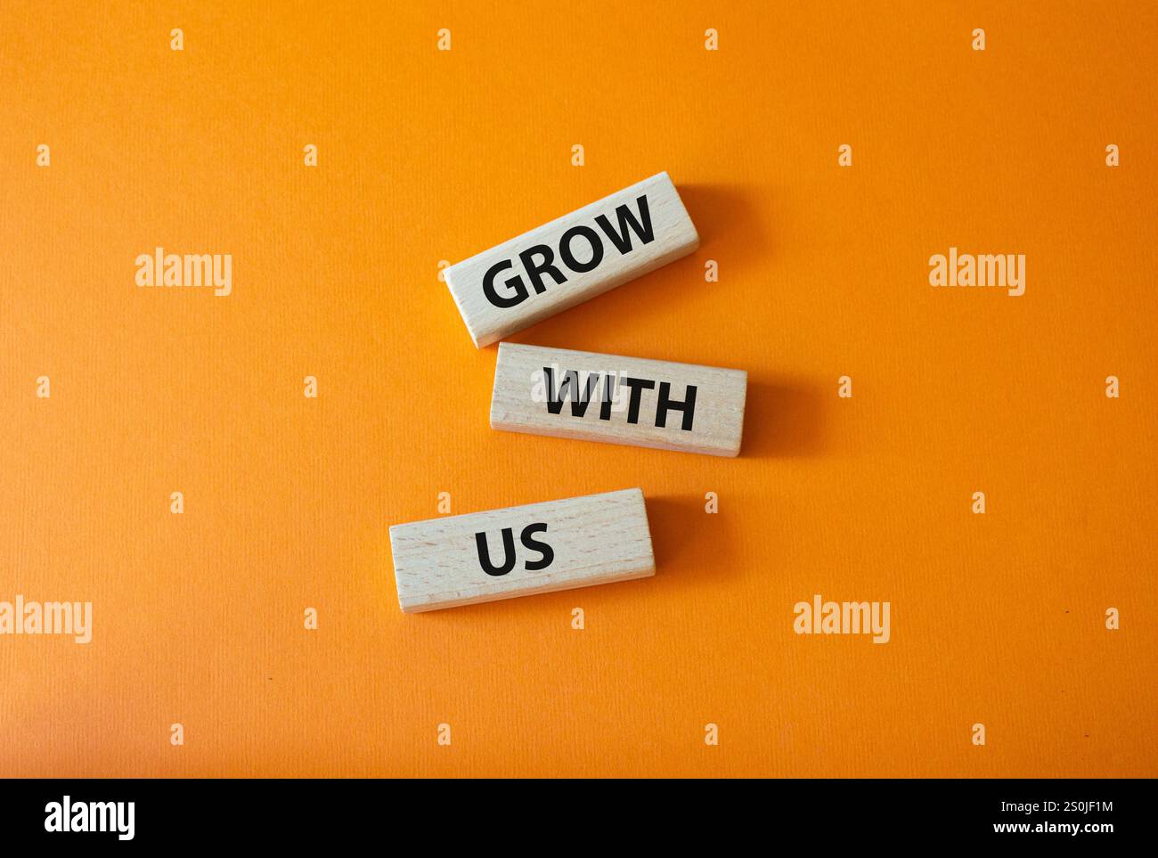 Grow with us symbol. Wooden blocks with words Grow with us. Beautiful ...