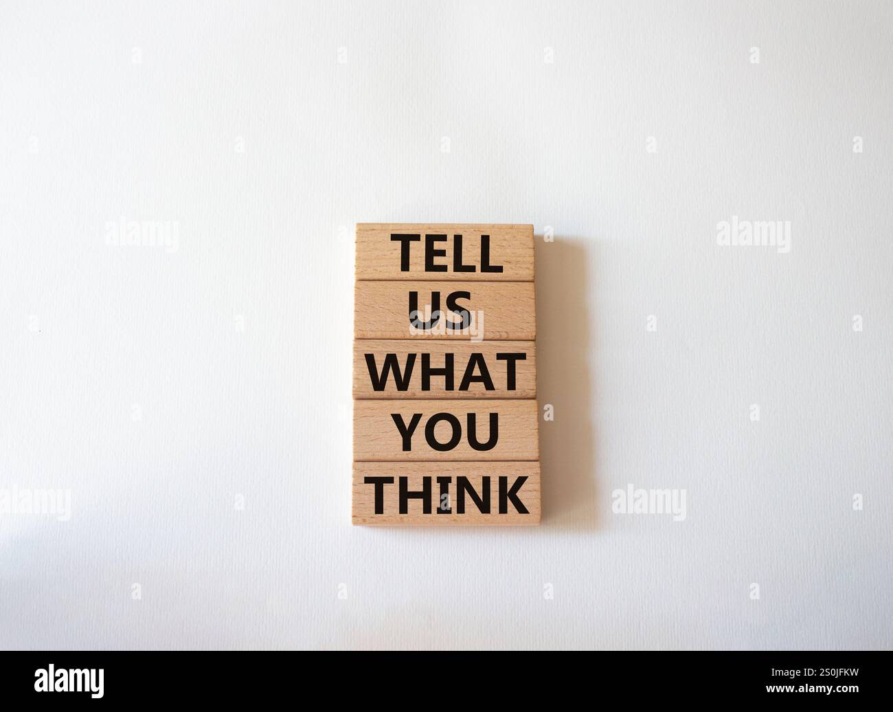 Tell us what you think symbol. Wooden blocks with words Tell us what ...