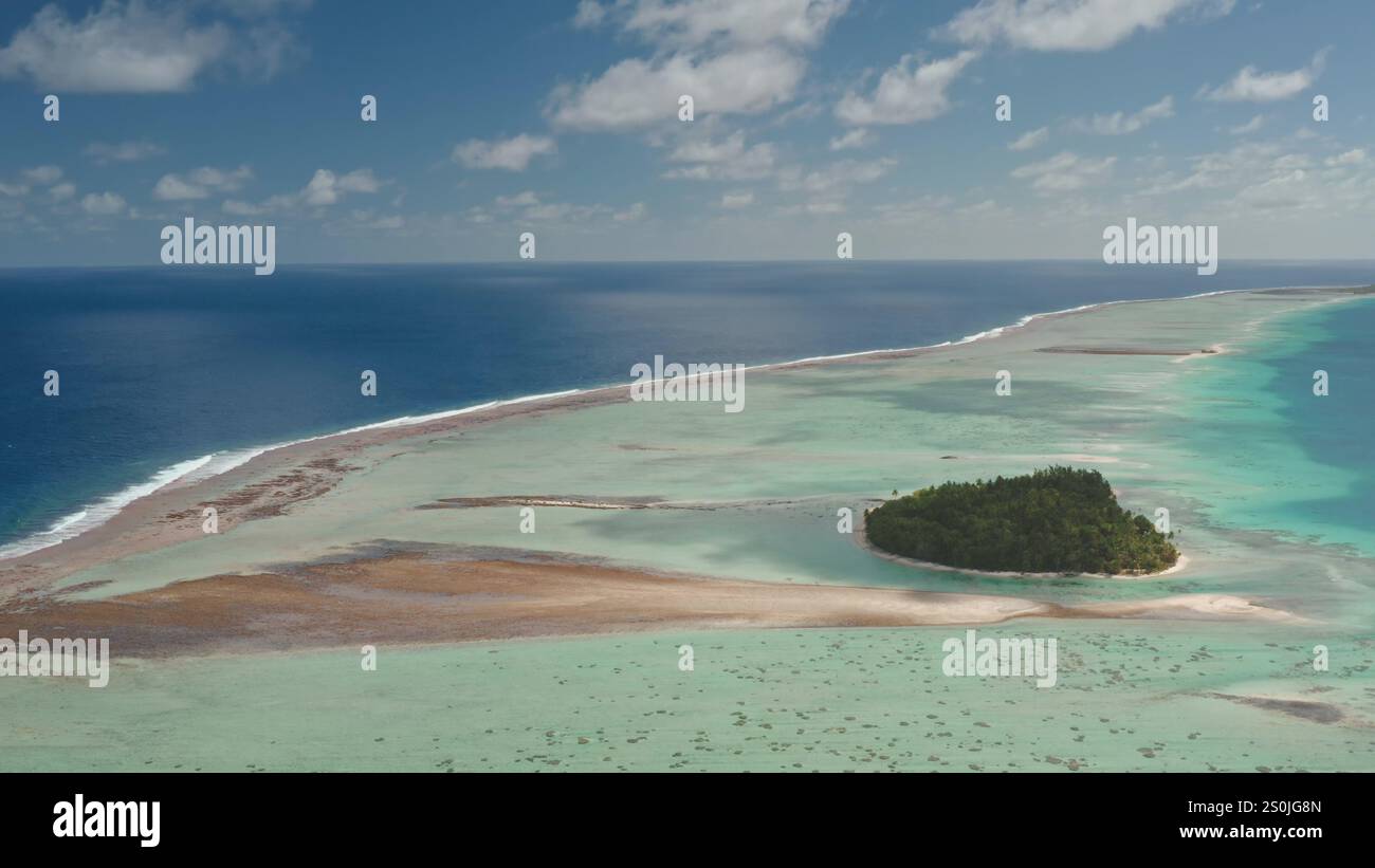 Aerial view of Tikehau island atoll in French Polynesia. Vibrant pink sand and turquoise lagoon ...