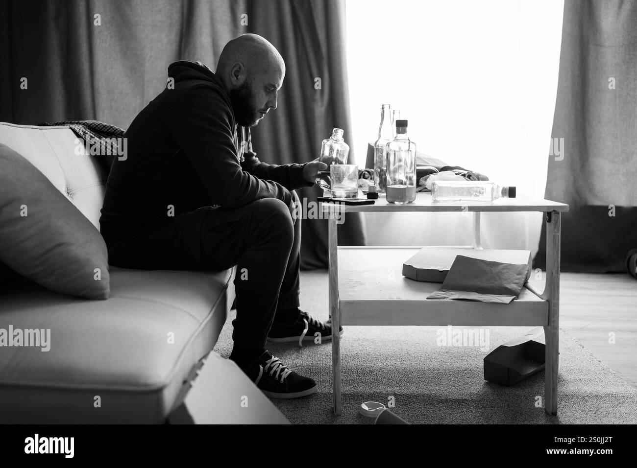 Young sad drunk man drinking alcohol feeling empty, lonely and ...