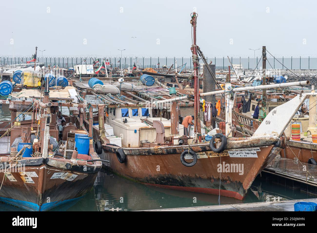 Fishing boats and Dhows in Kuwait City moored up next to the Fish ...
