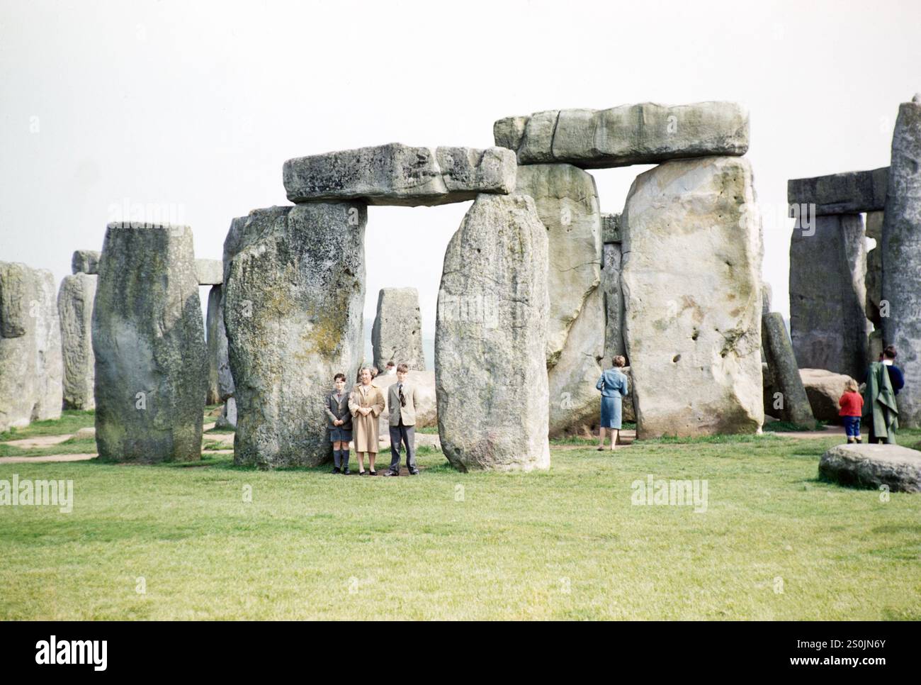People exploring the standing stones at Stonehenge neolithic site ...