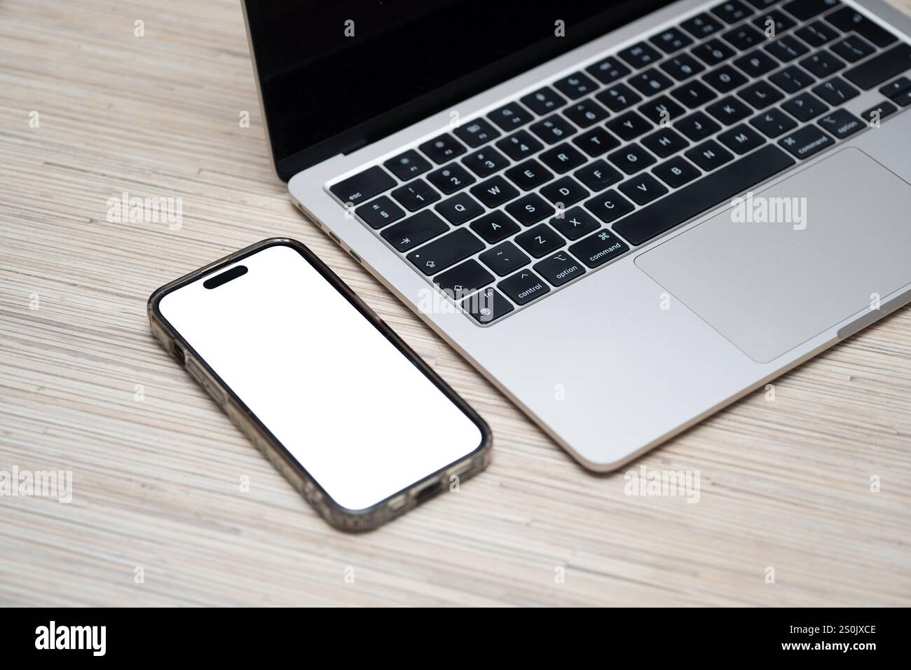 Smartphone with White Screen Mockup Next to Laptop Stock Photo - Alamy