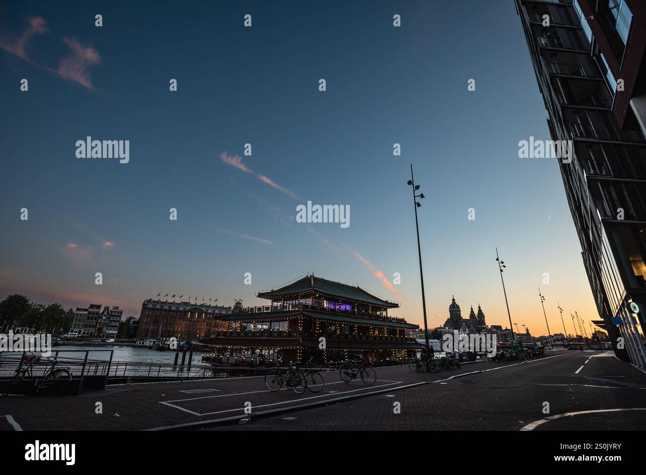 Scenic Waterfront with Sea Palace at Sunset - Amsterdam, Netherlands ...