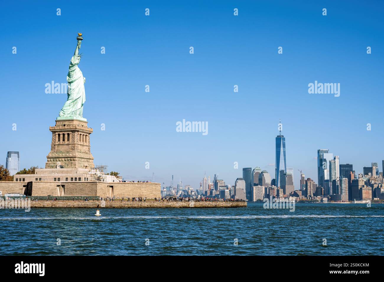 The famous Statue of Liberty in New York with the skyline of Manhattan ...