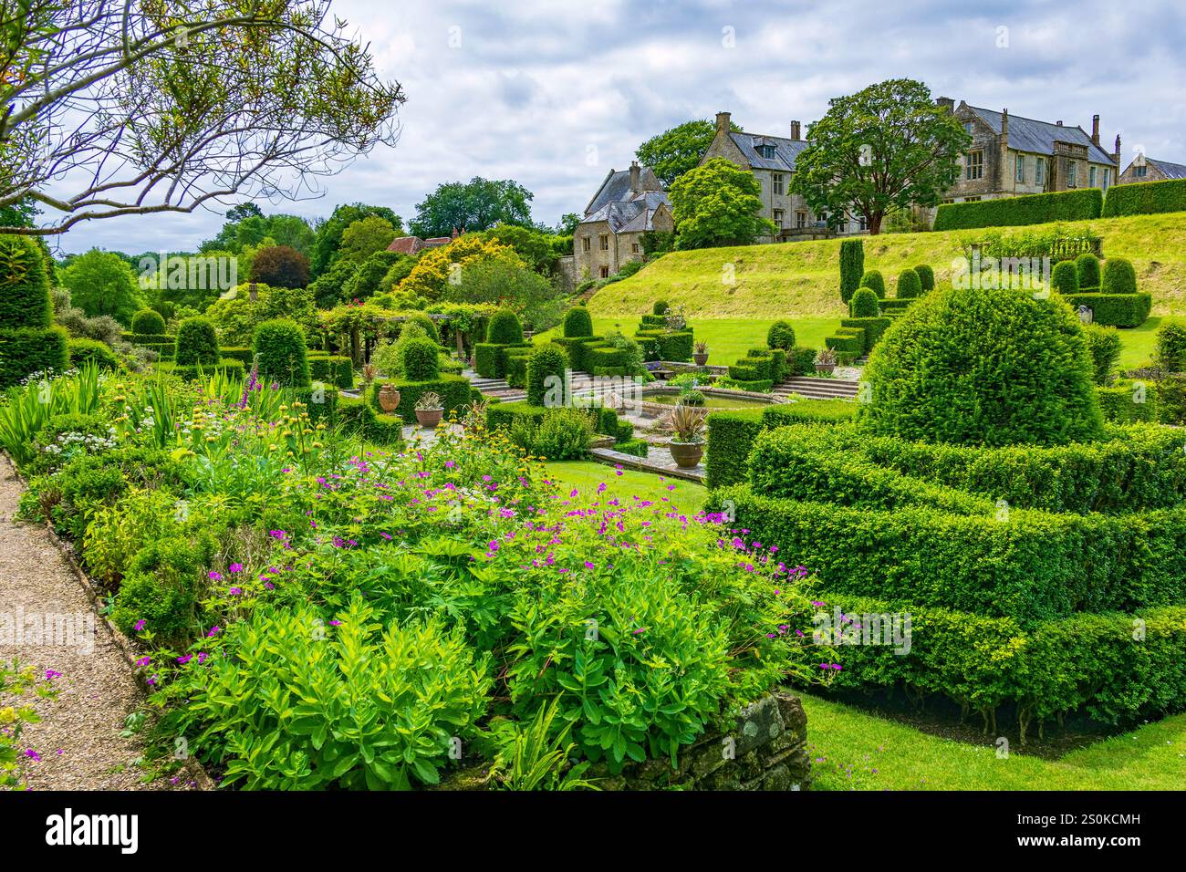 A variety of topiary shaped hedges and trees in the Italianate Fountain ...