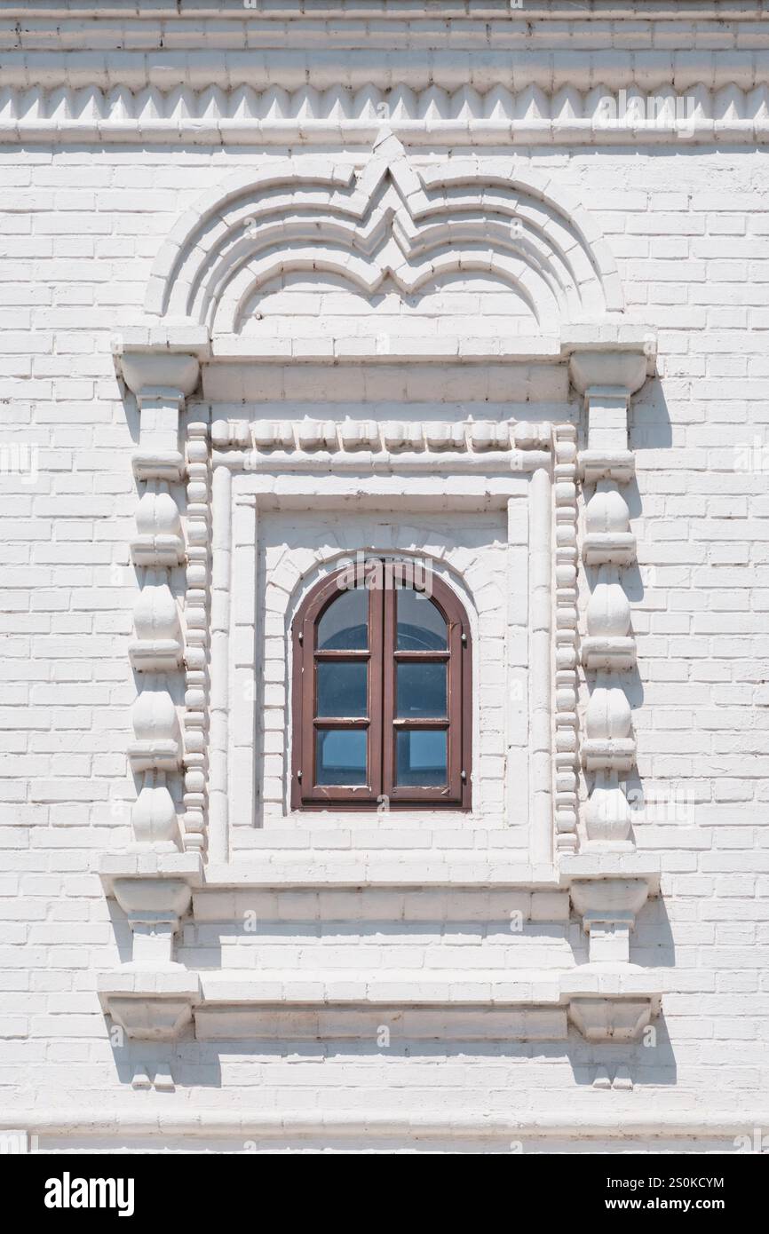 Decorative arched historic window on white brick wall Stock Photo - Alamy