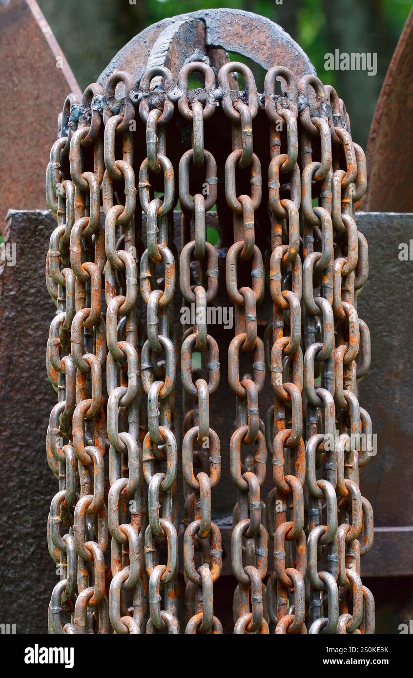 A close-up view of rusty chains hanging from a metal structure ...