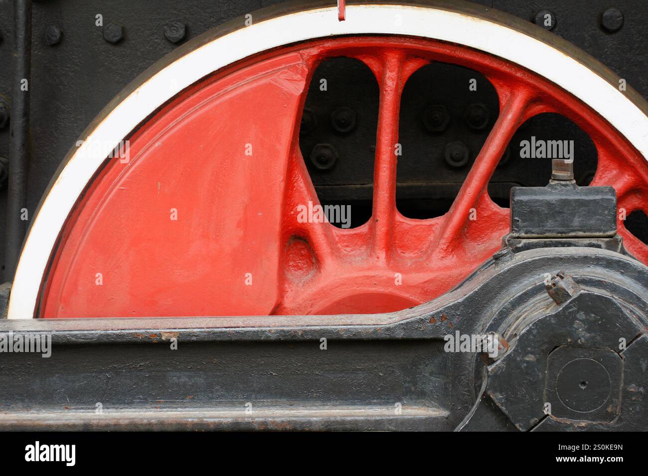 Detailed close-up view showing the vibrant red spoked wheels and ...