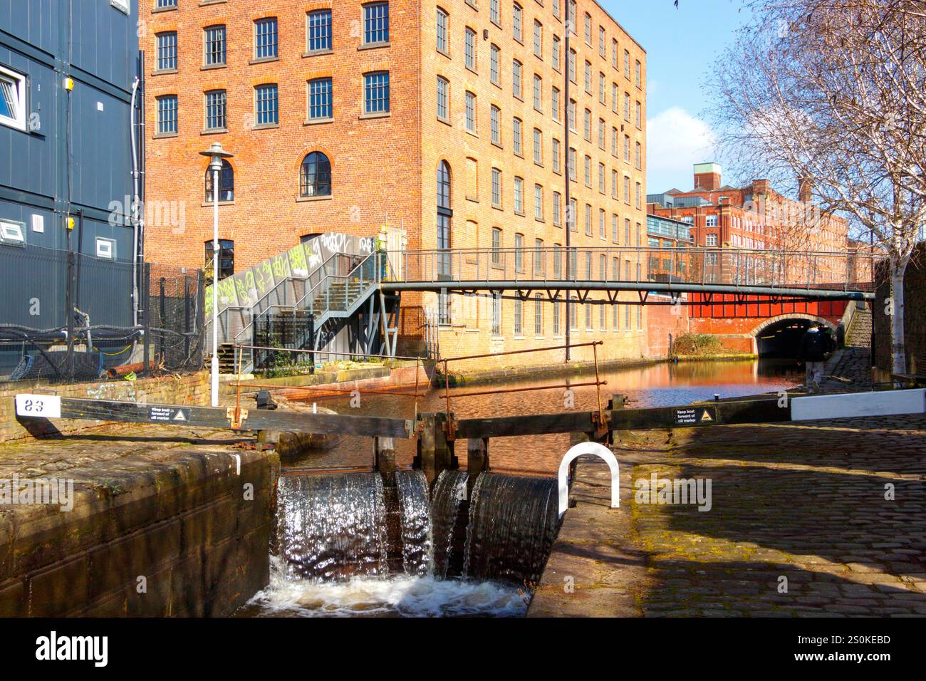 industrial red brick building with canal bridge and lock gatres new ...