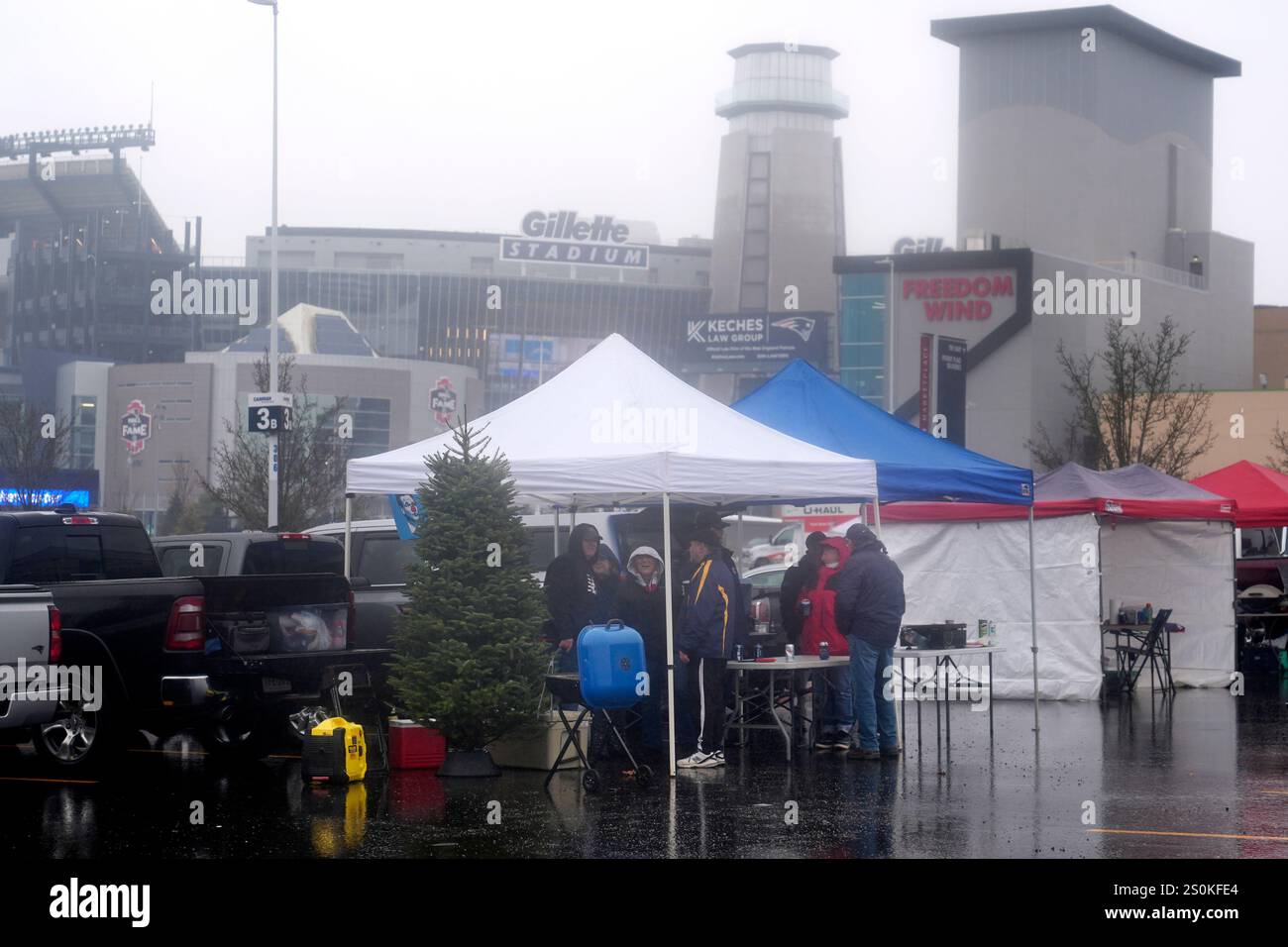 Fans tailgate in the rain prior to an NFL football game, Saturday, Dec ...