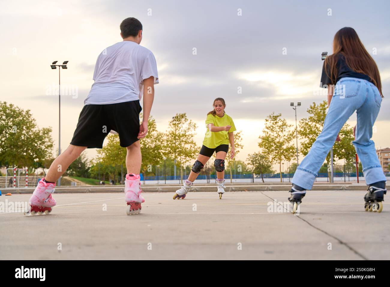 Instructor teaching skating techniques in a group Stock Photo - Alamy