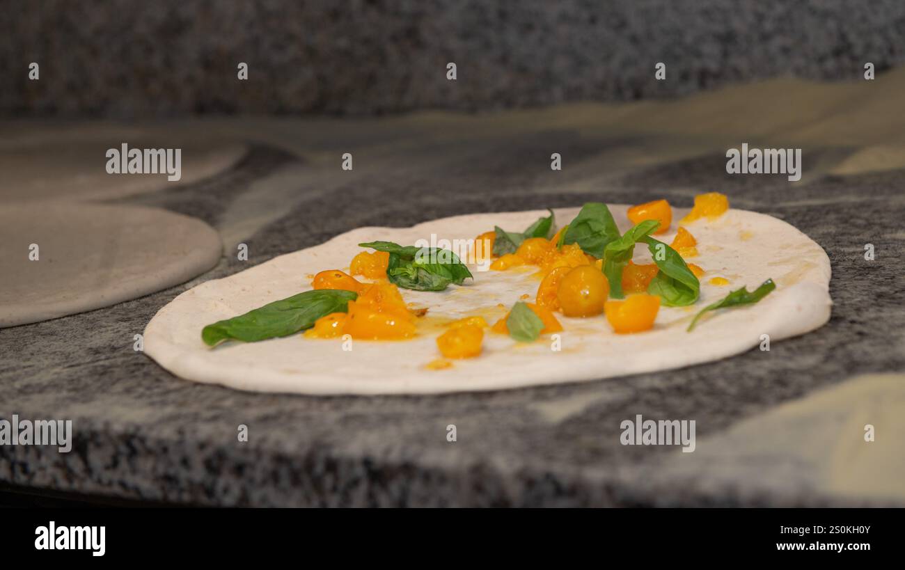 Preparing the pizza before putting it in the oven Stock Photo - Alamy