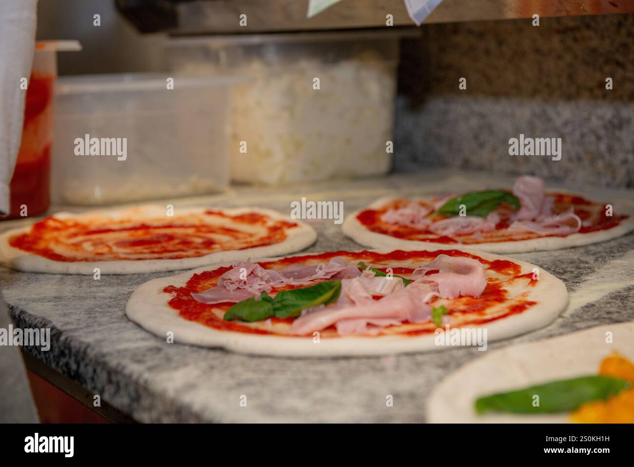 Preparing the pizza before putting it in the oven Stock Photo - Alamy
