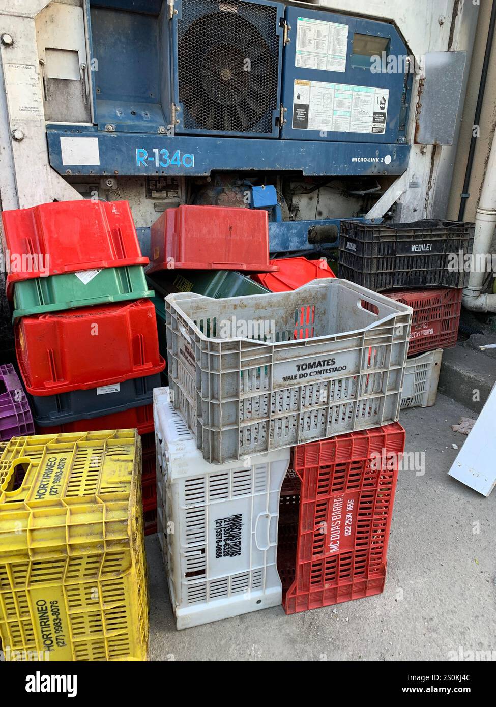 Several vented empty colorful plastic food crates Stock Photo - Alamy