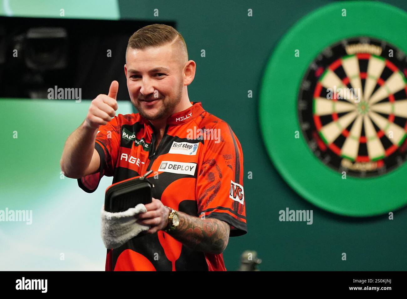 Nathan Aspinall celebrates after winning his third round match against ...