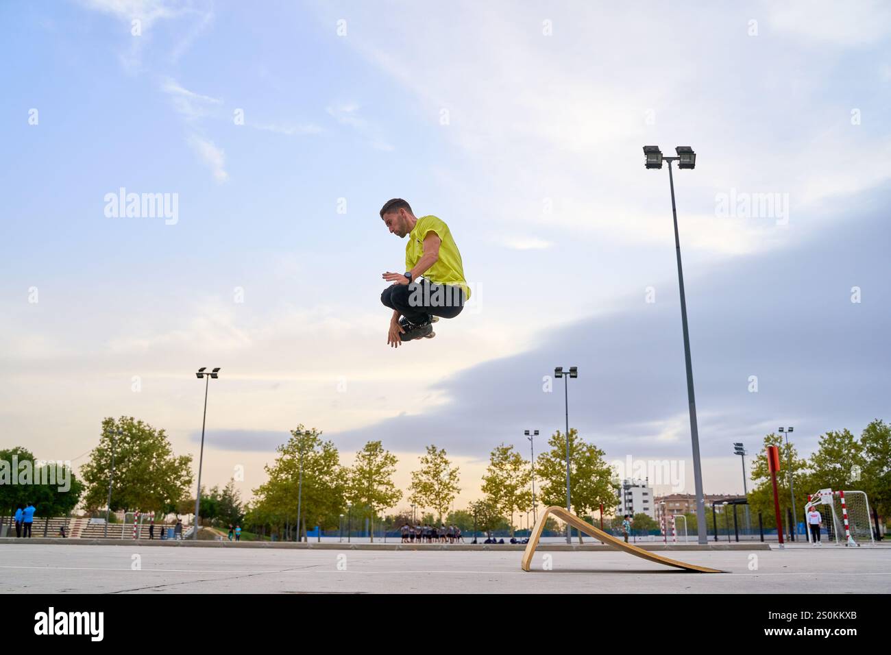Skater performing a high jump over a ramp at sunset Stock Photo - Alamy