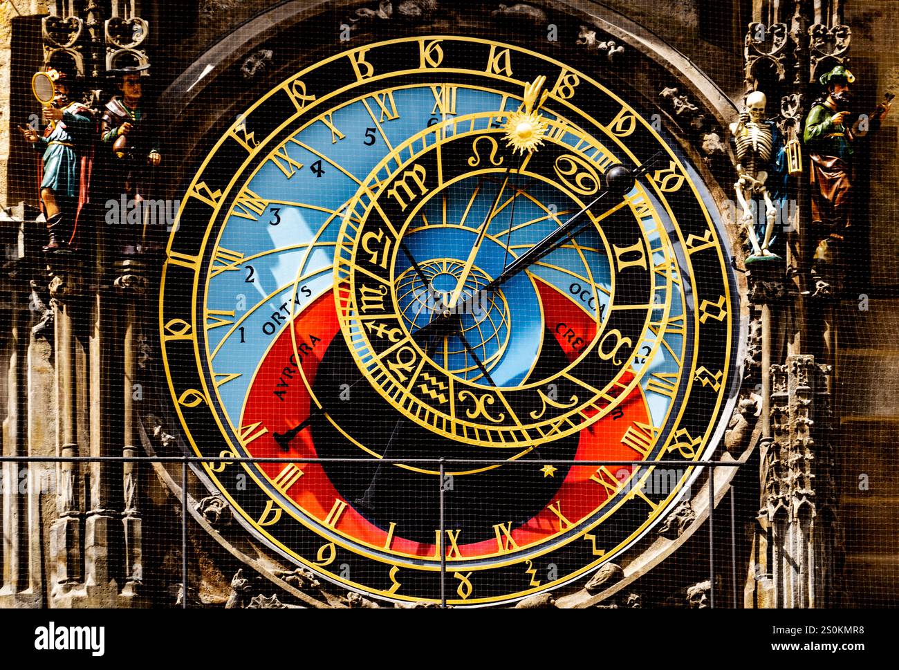A close-up view of an ornate astronomical clock featuring zodiac signs ...