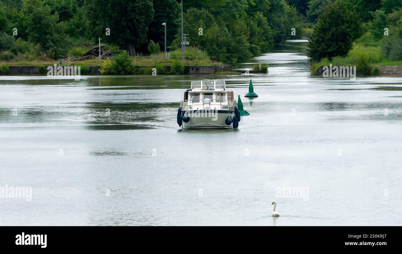 Small Boat Cruising on a Narrow Scenic River in a Forested Area Stock ...