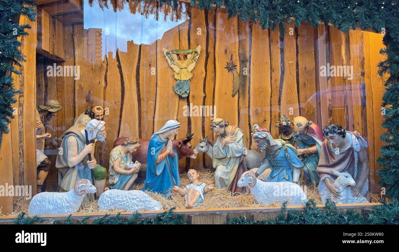 A nativity scene diorama displayed in a wooden frame, featuring ...