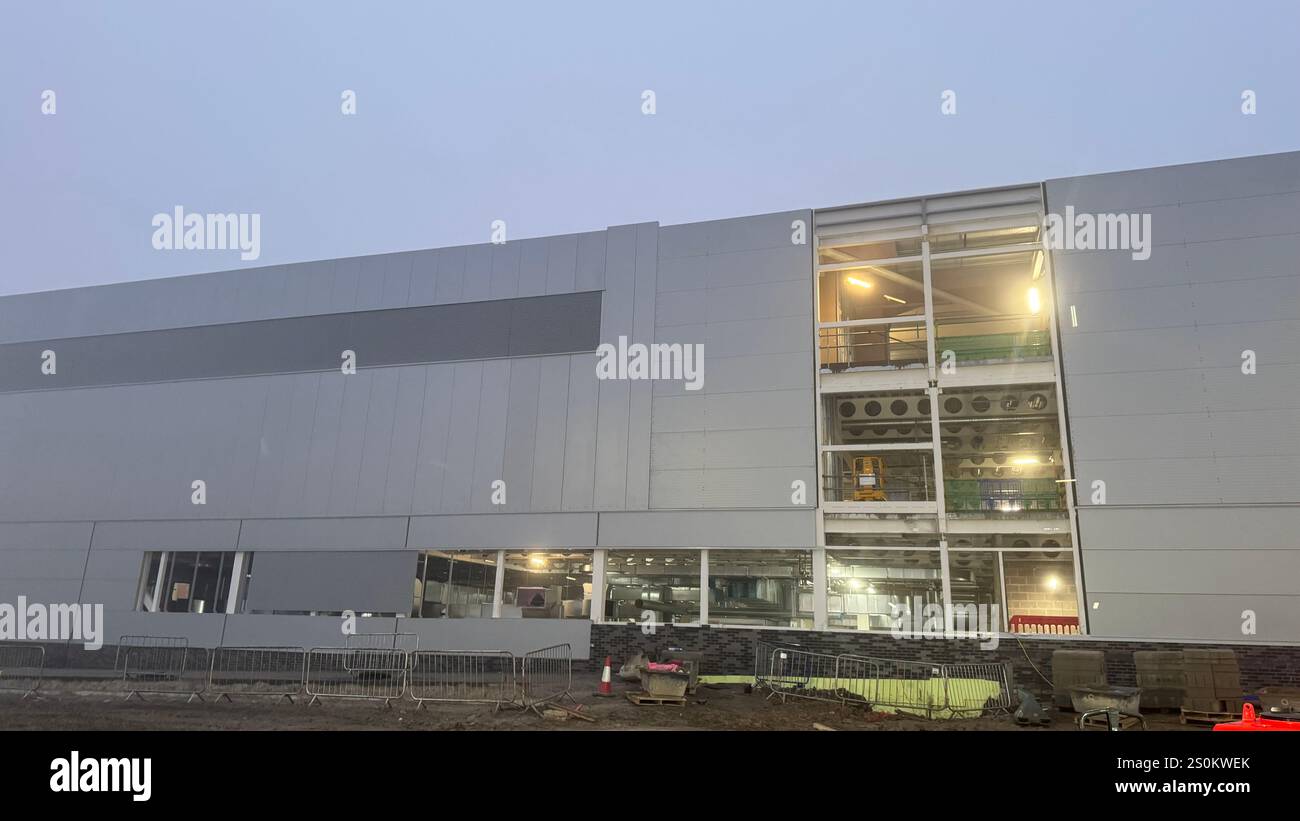 Large grey commercial building under construction. Exterior mostly clad ...