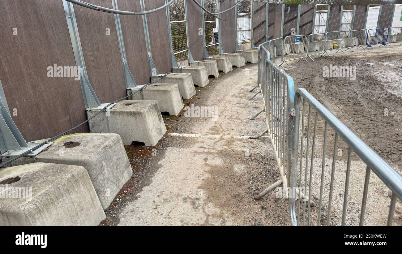 A temporary construction site barrier consisting of a brown wall ...