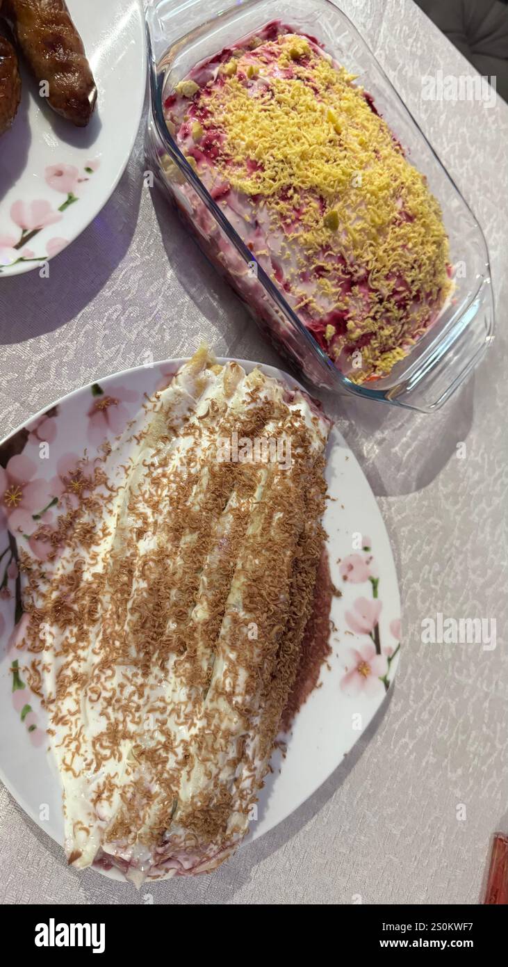 A high-angle, close-up shot shows two dishes: a beet salad topped with ...
