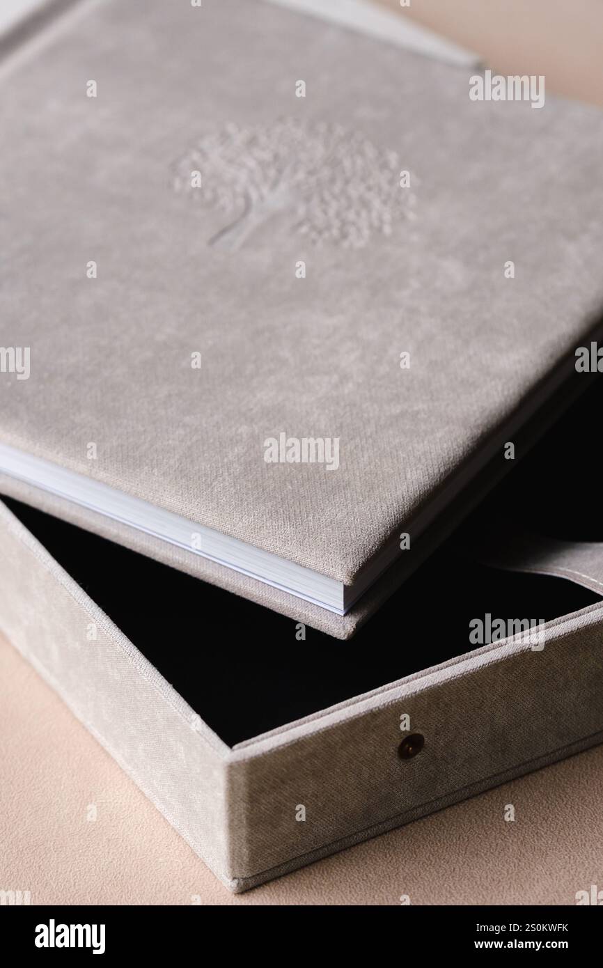 The photo book is grey in a soft cloth cover. the concept of creating ...