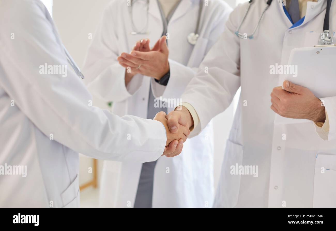 Doctors shaking hands reaching agreement in treatment or finishing ...