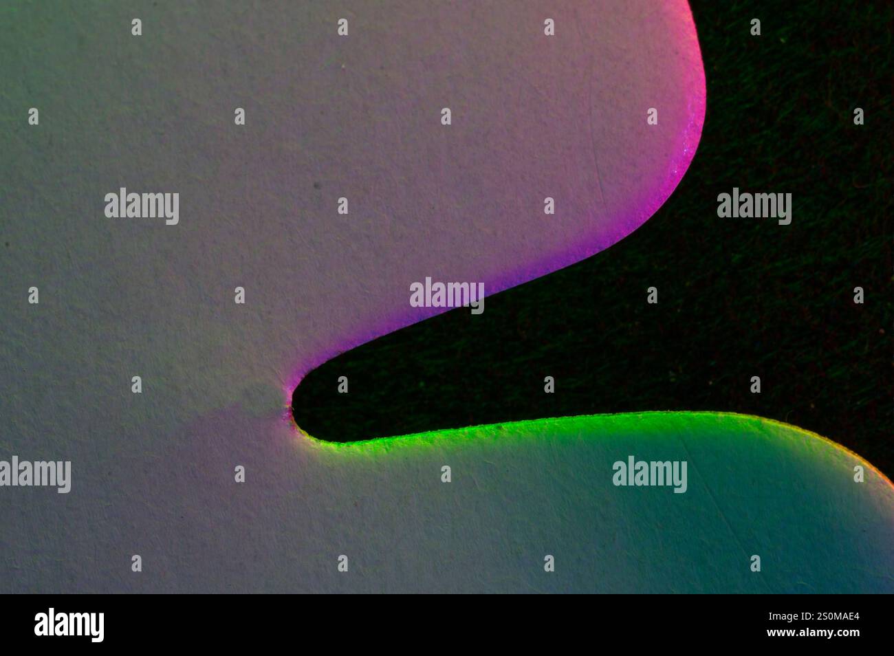 Pink and green edges on a white shape on a black abstract background ...