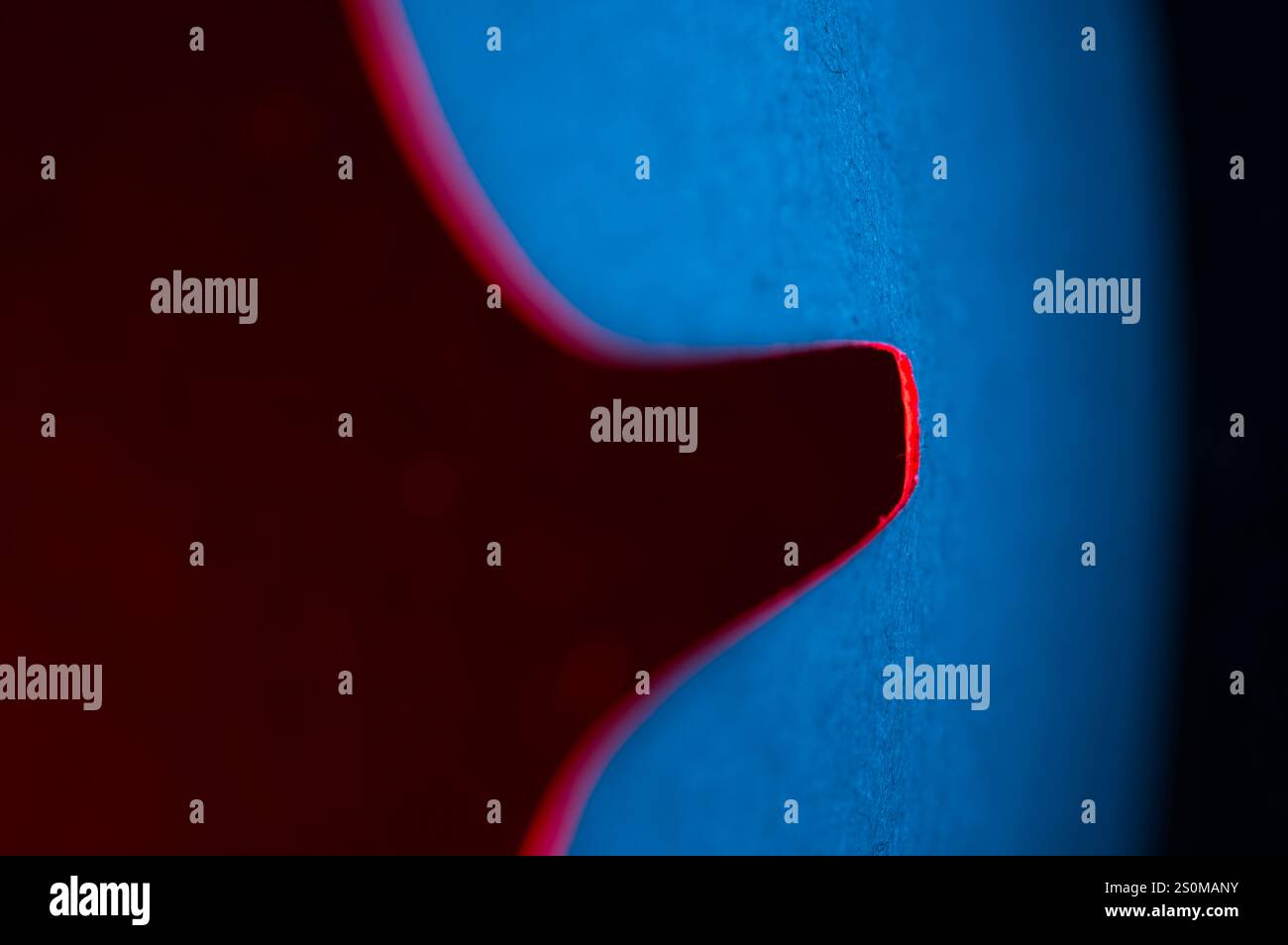Abstract shape in blue with red edge on a reddish background with copy ...
