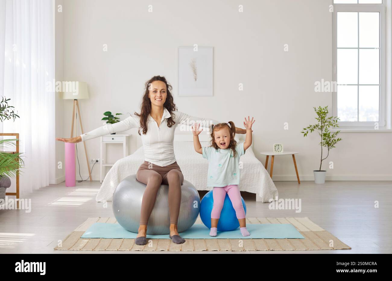 Happy sporty playful funny active family on fitness ball, mother parent, babysitter, small child ...