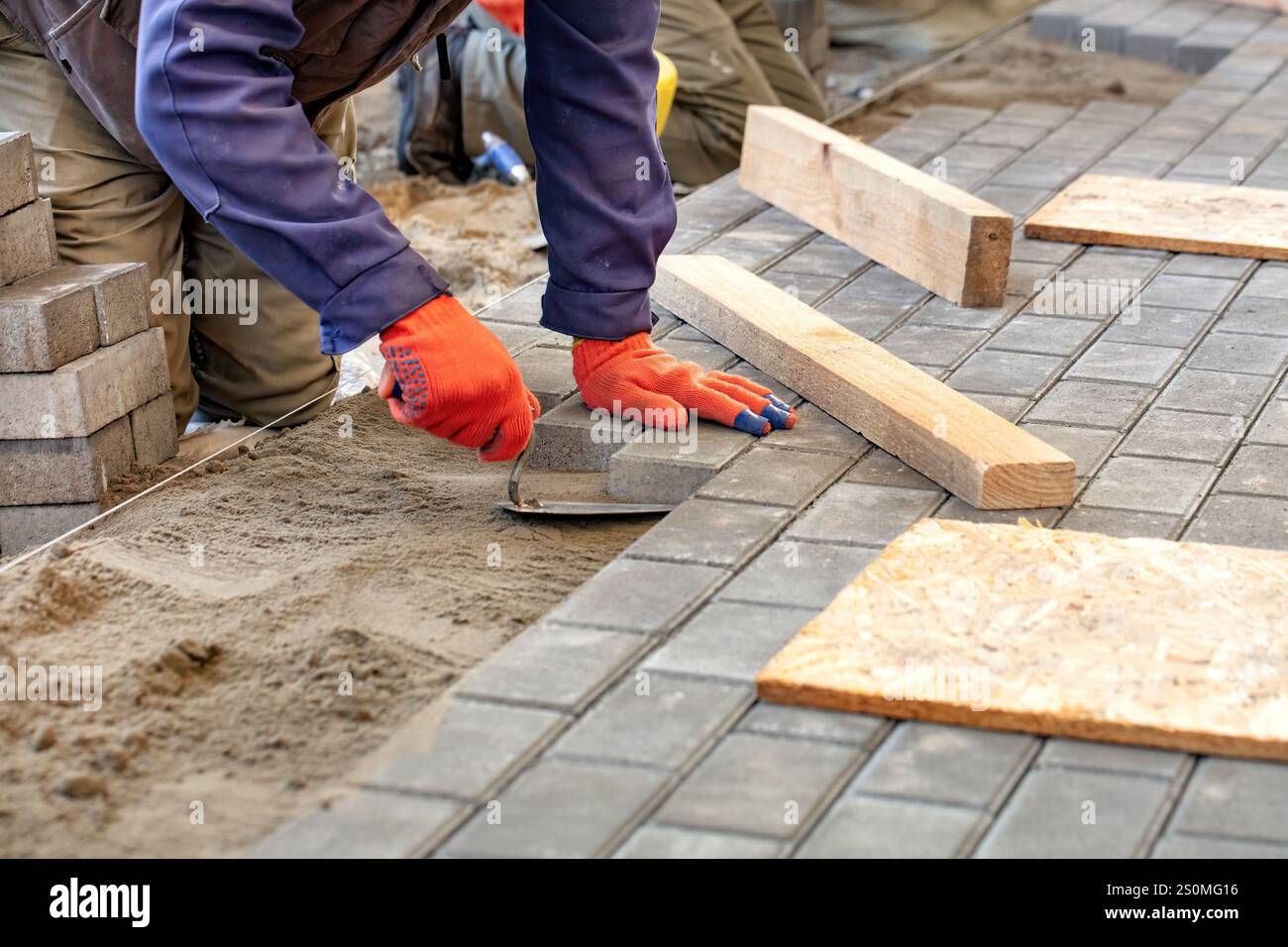 Crafting a durable pathway with precision during a sunny construction ...