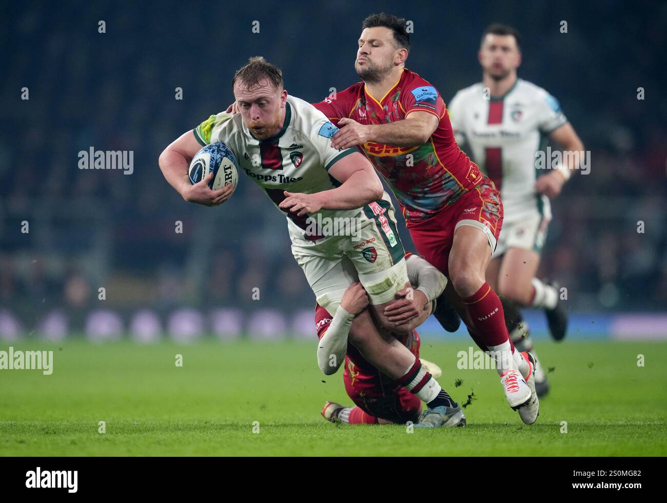 Leicester Tigers' Tommy Reffell (left) is tackled by Harlequins' Nick ...