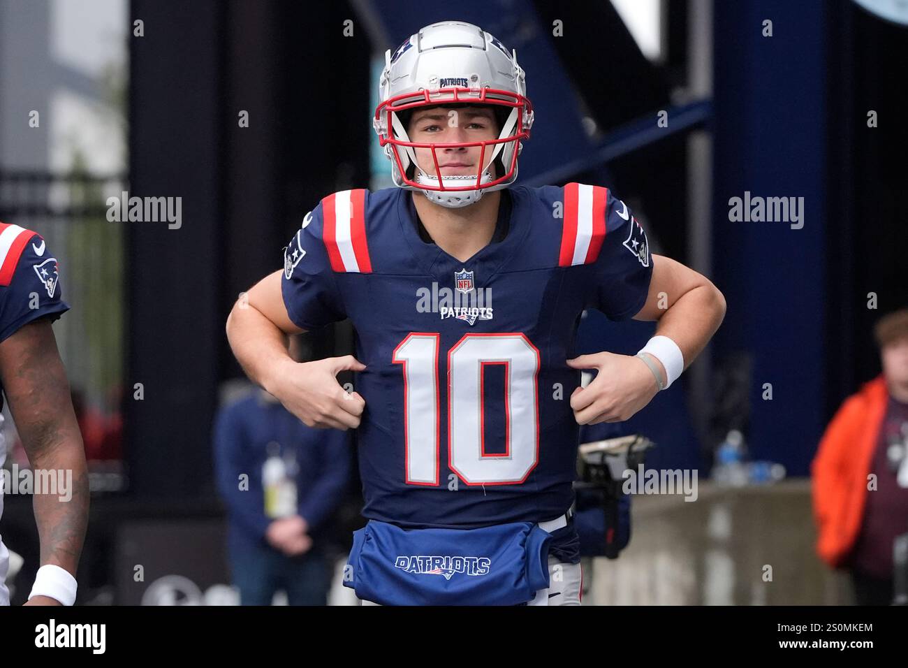 New England Patriots quarterback Drake Maye (10) walks onto the field ...