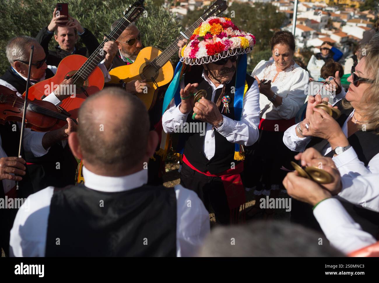 A man wearing a traditional costume is seen playing instruments before ...