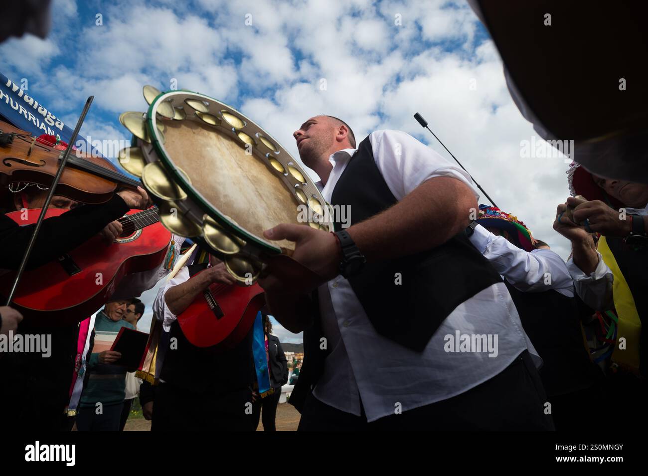 A musician wearing a traditional costume is seen playing an instrument ...