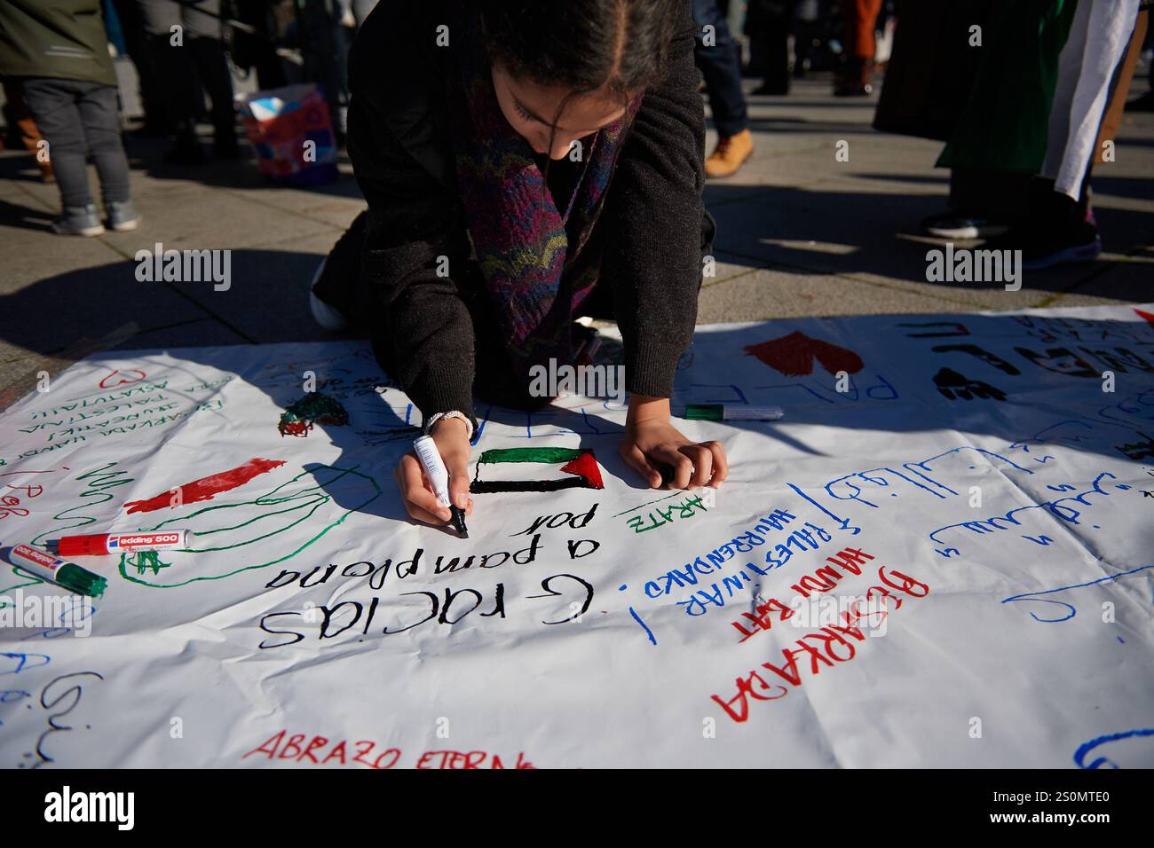 Hajar Salim, a Palestinian girl, paints a Palestinian flag on a mural ...