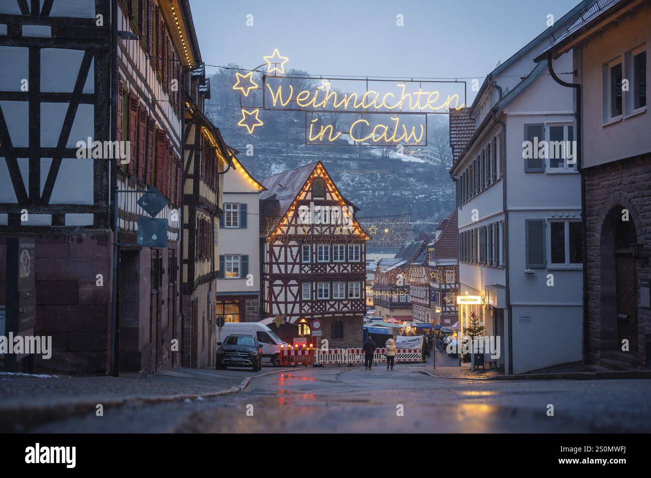 Christmas-lit street with half-timbered houses and wintry backdrop ...